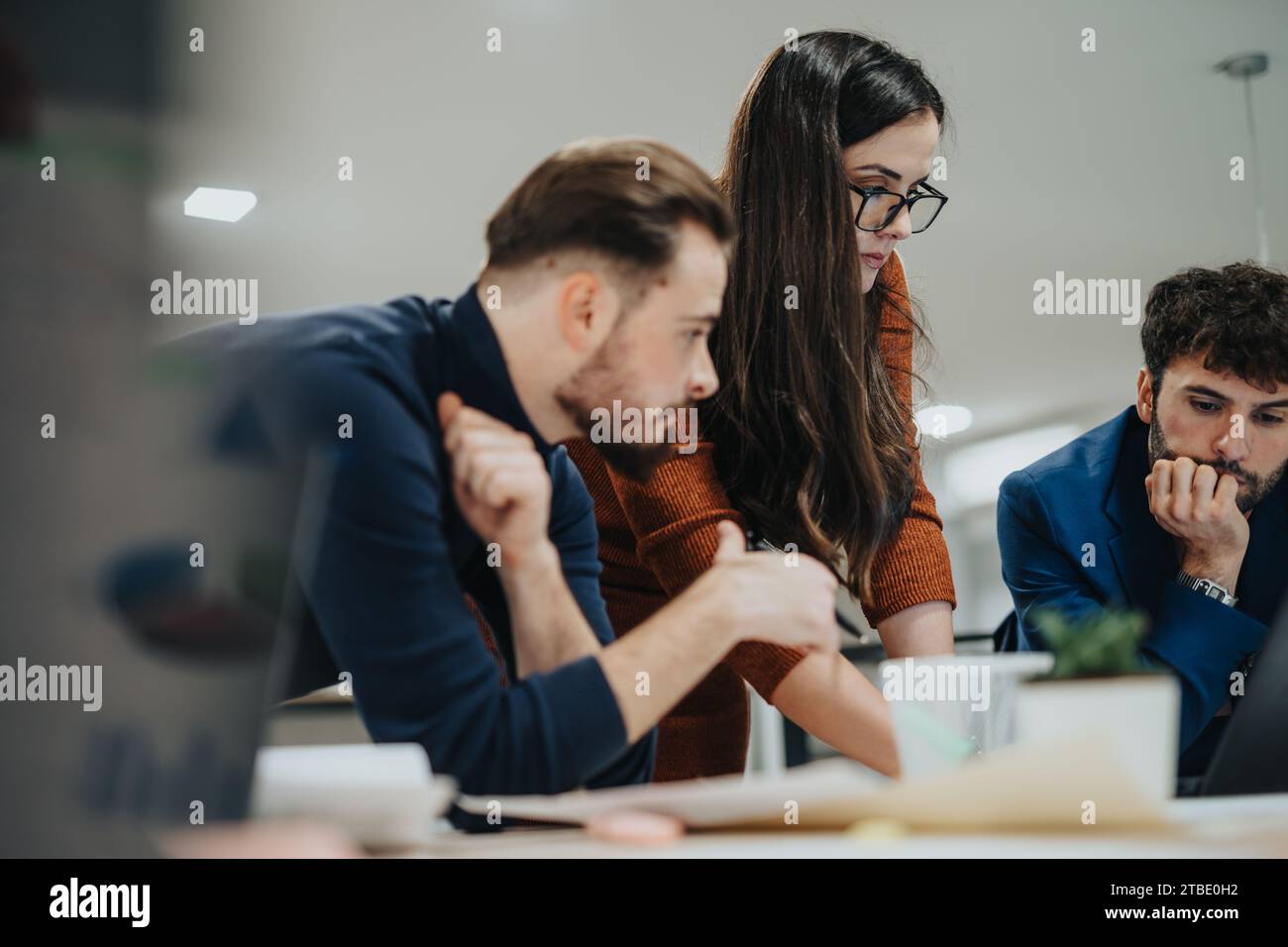 Diverse colleagues collaborate on a late-night project, discussing ...