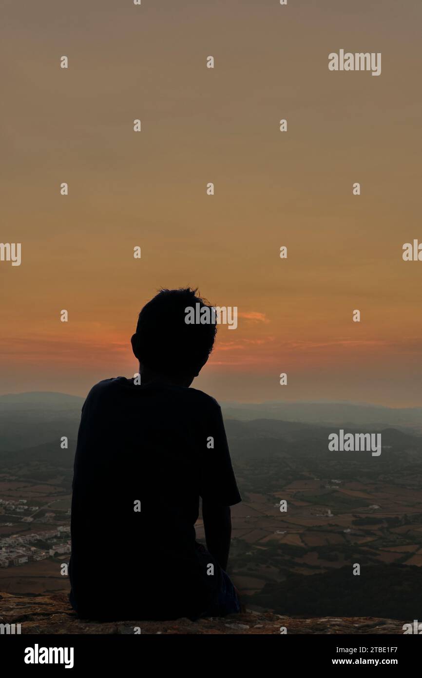 "Mountain Sunset Serenity: A Child's Silhouette in Contemplation Stock ...