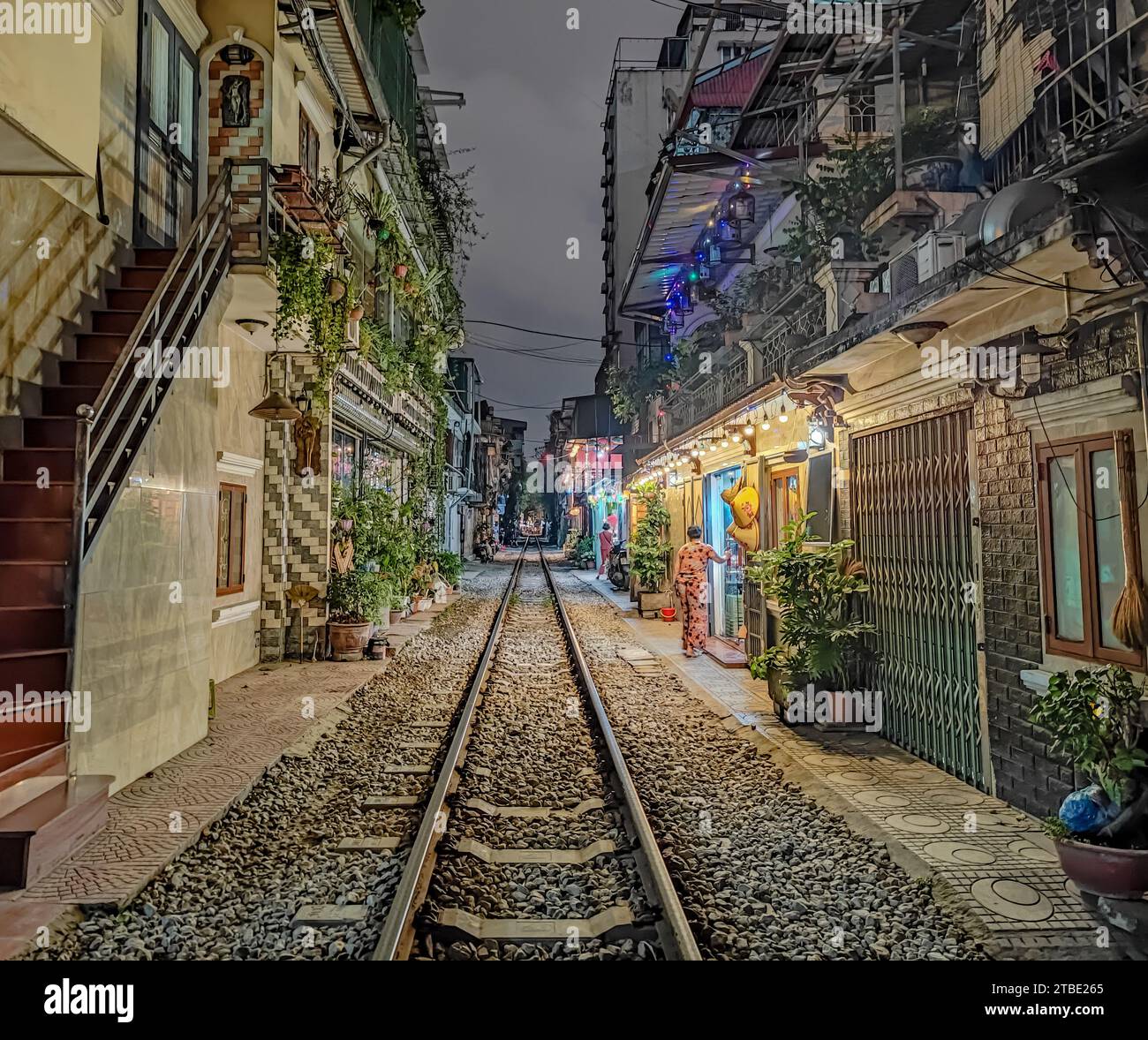 Hanoi train street in Vietnam at night. A narrow street of the Hanoi ...