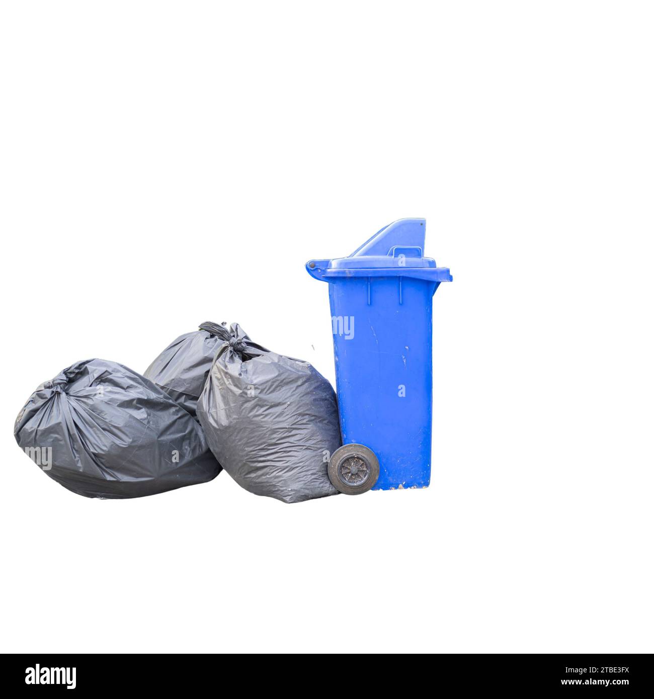 Image of a blue trash can situated next to two black garbage bags Stock ...