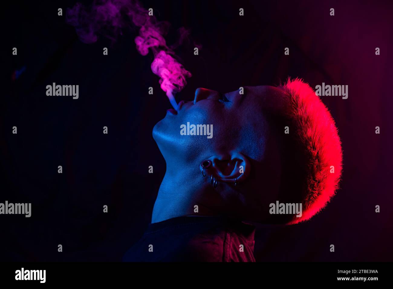 Profile Asian woman with short haircut smoking in neon light Stock ...