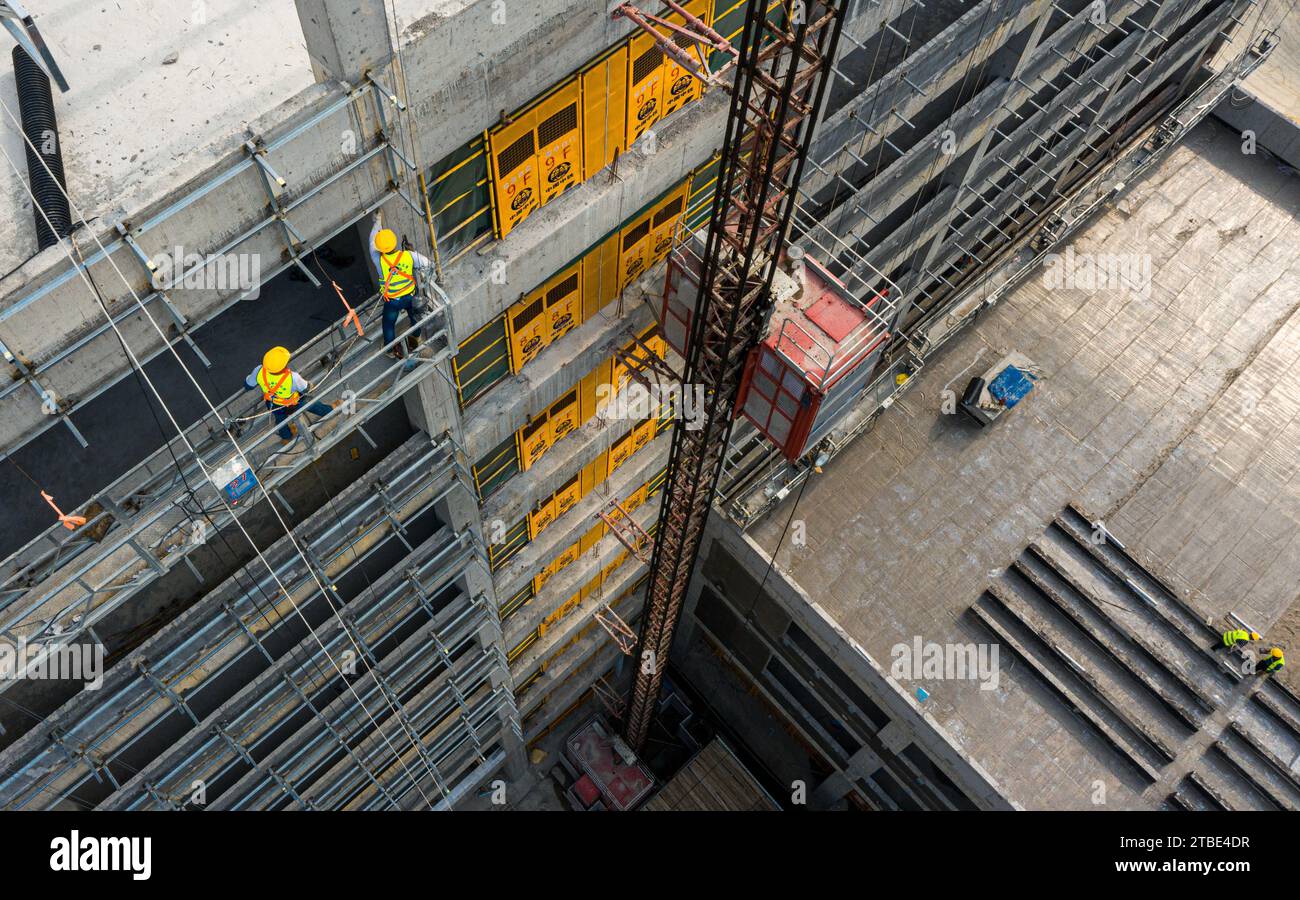 At a construction site of a building under construction, a group of ...