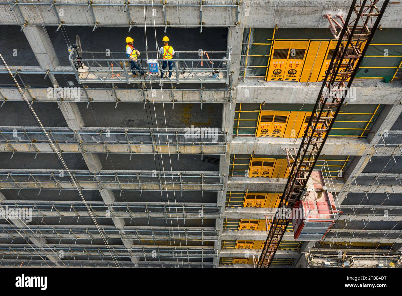 At a construction site of a building under construction, a group of ...