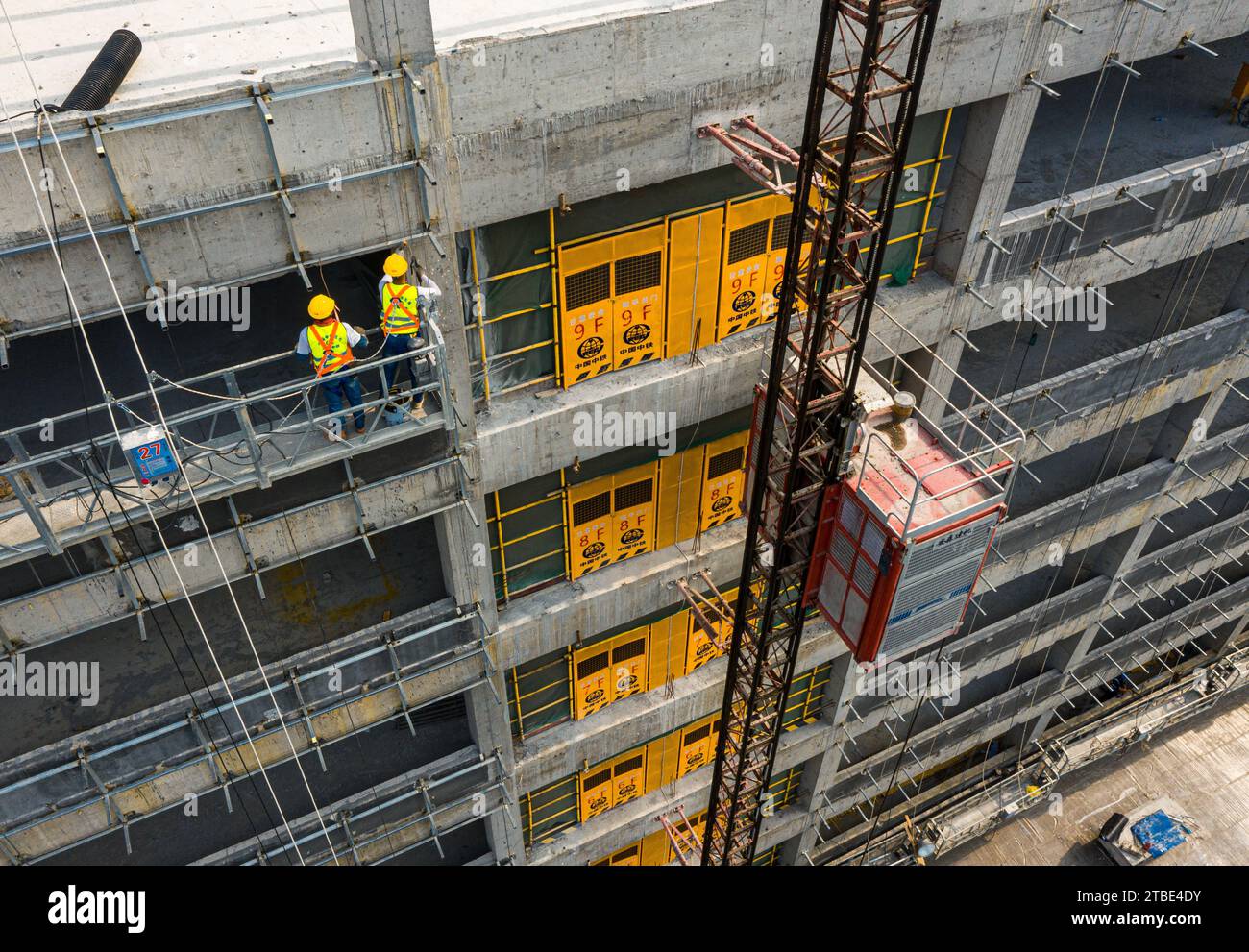 At a construction site of a building under construction, a group of ...