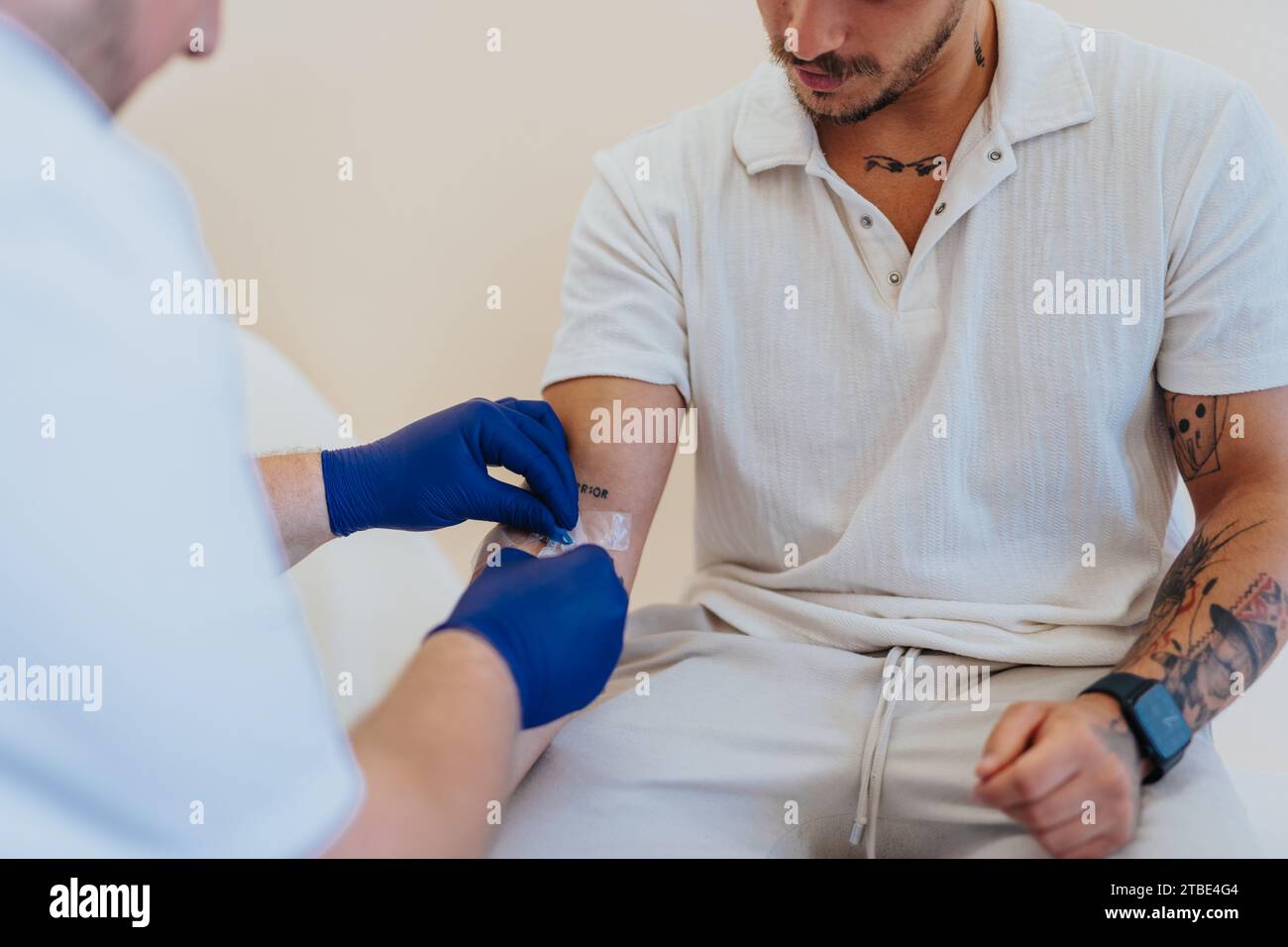 In a hospital room, a doctor provides care and consultation to a ...