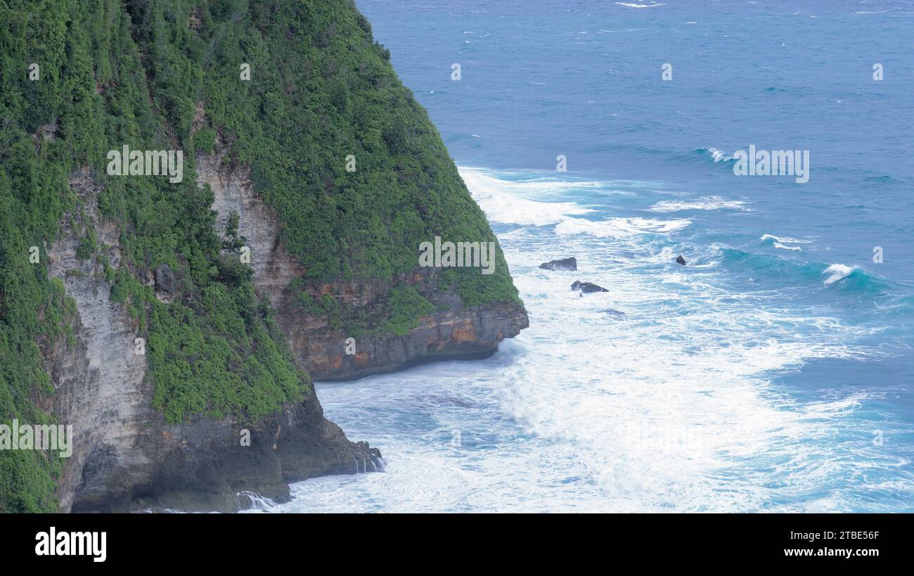 A stunning aerial view of an ocean landscape, featuring a rugged cliff ...