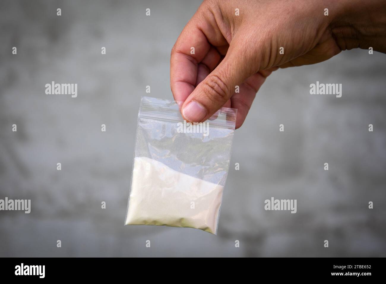A bag of white powder in hand. Image for prohibited substances ...