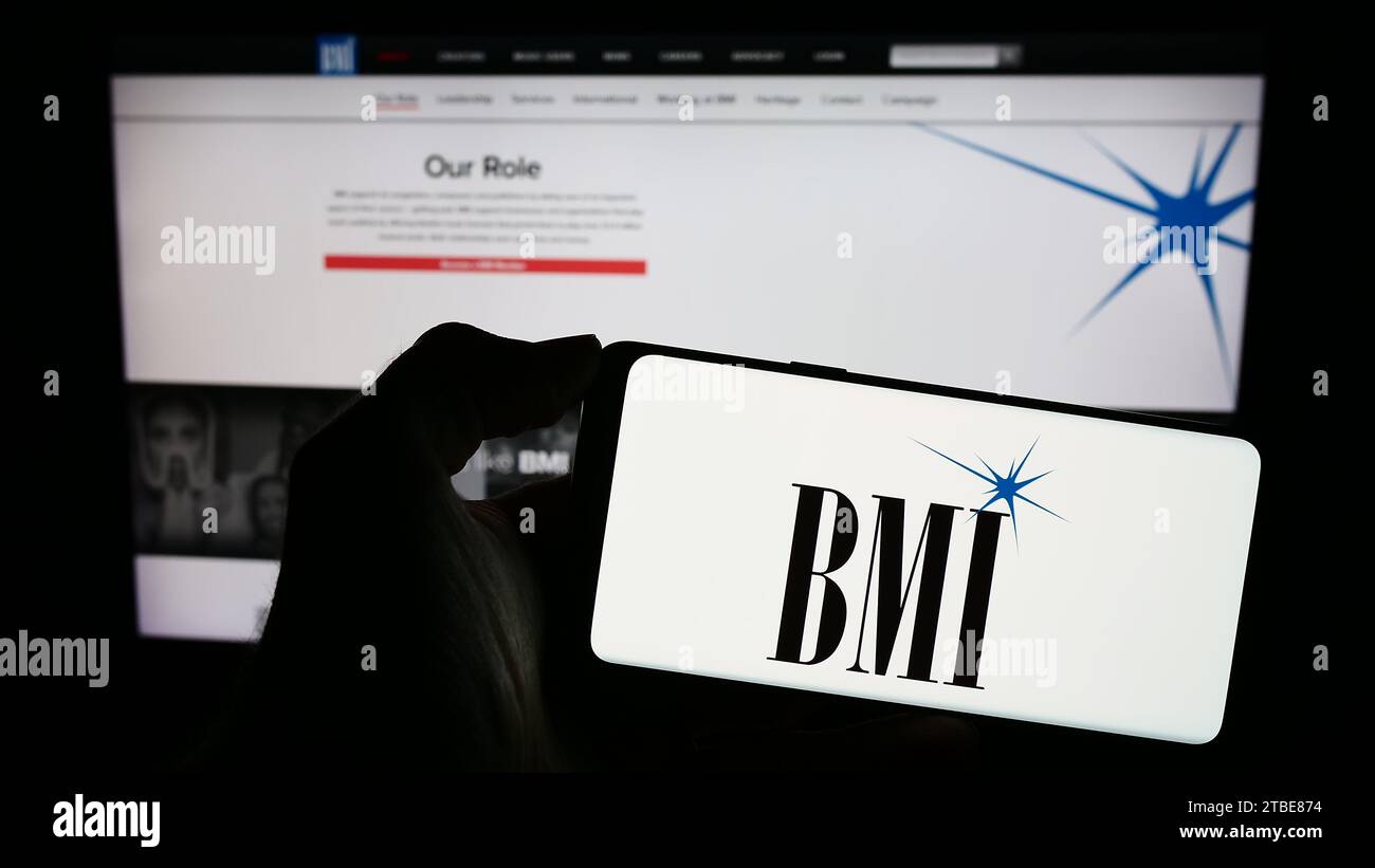 Person holding mobile phone with logo of US performance rights company ...