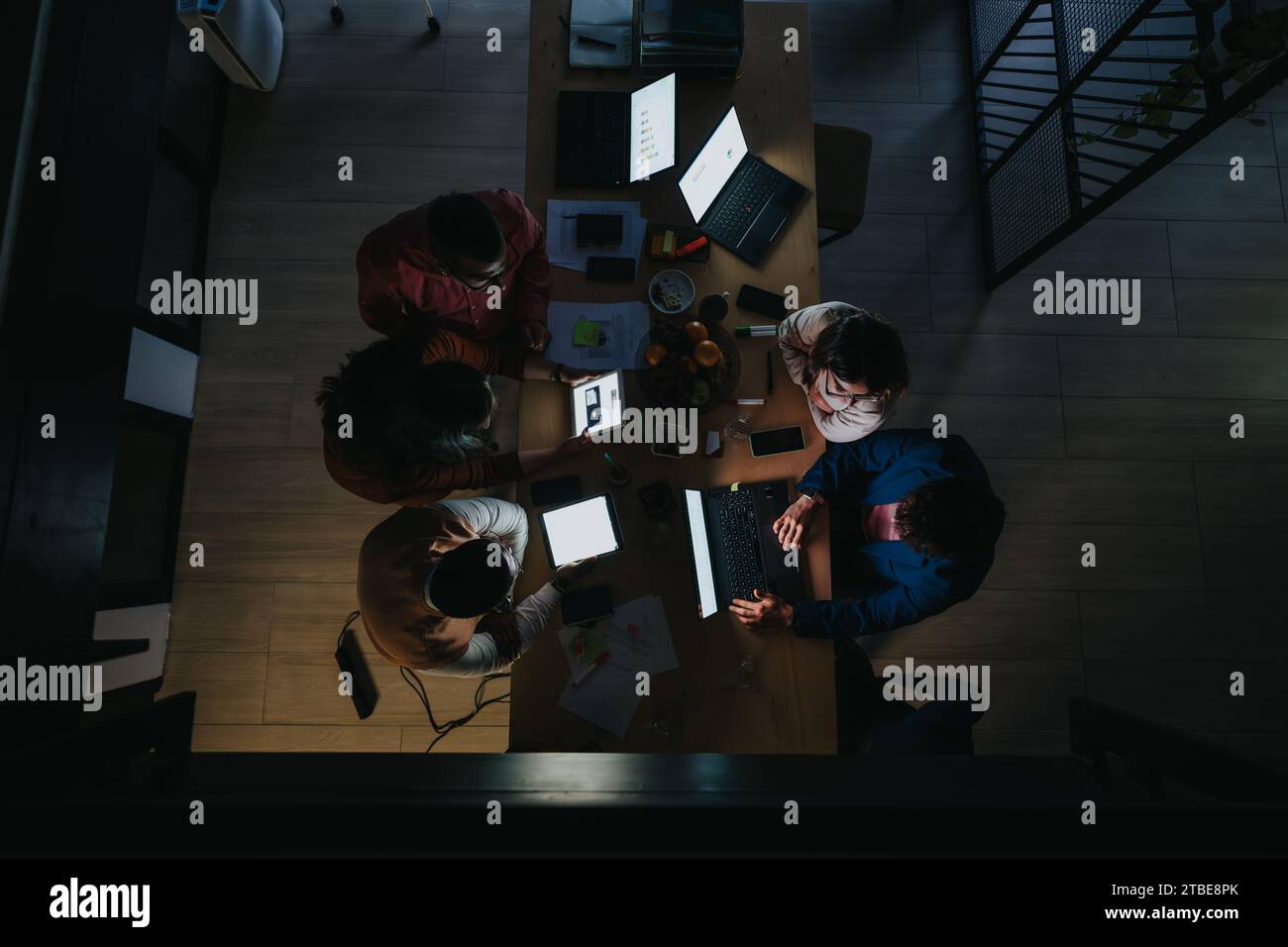 A cross generational team collaborating and discussing business ...