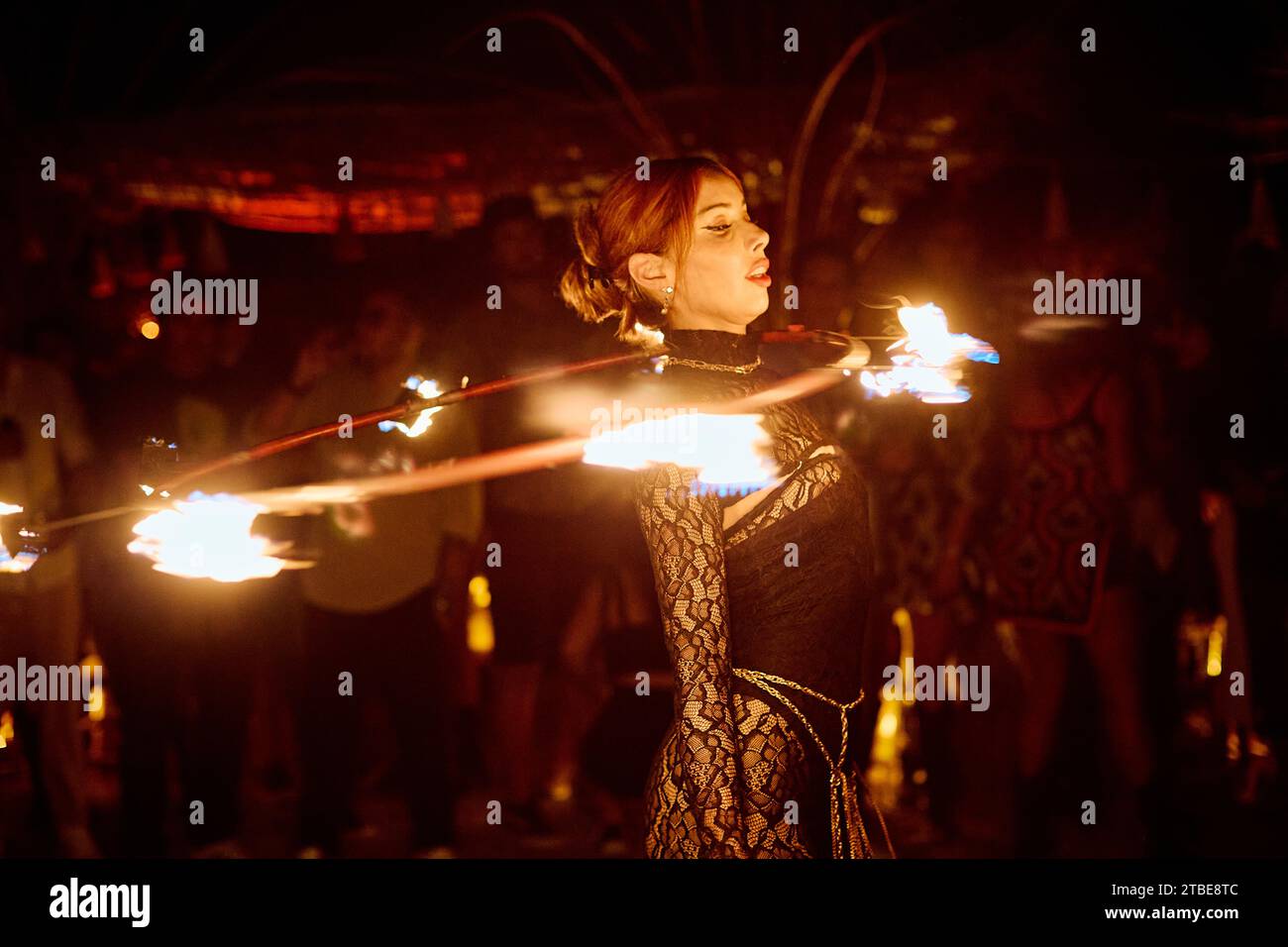 Artists perform a fire performance, under the dark night and before an ...