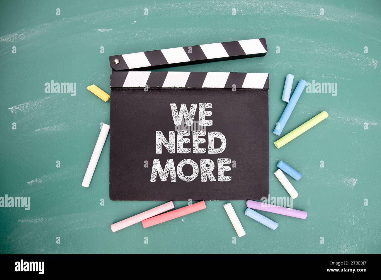 We need more. Movie clapper and colored pieces of chalk Stock Photo - Alamy
