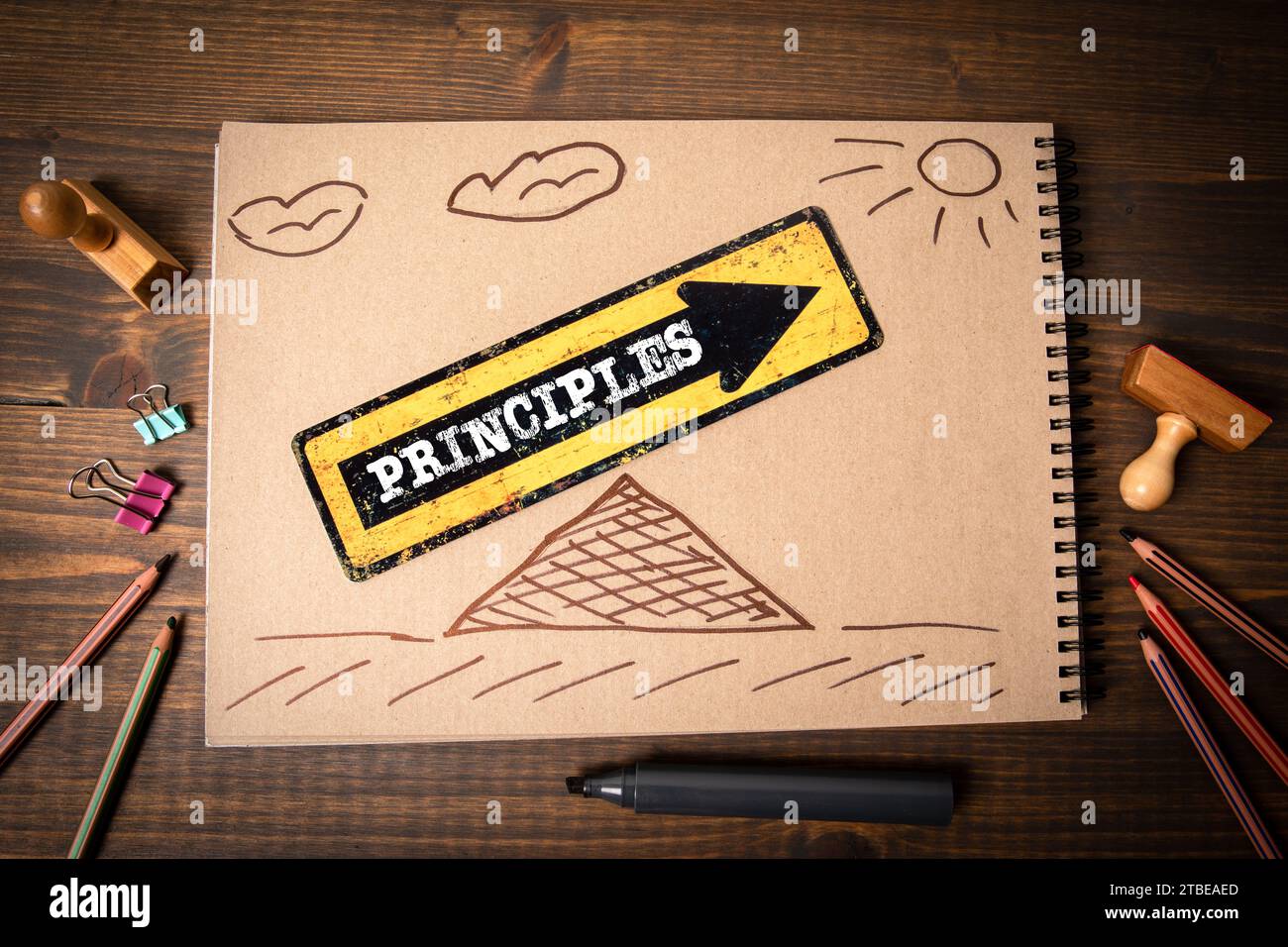 Principles. Pointing arrow and stationery on wooden office table Stock ...