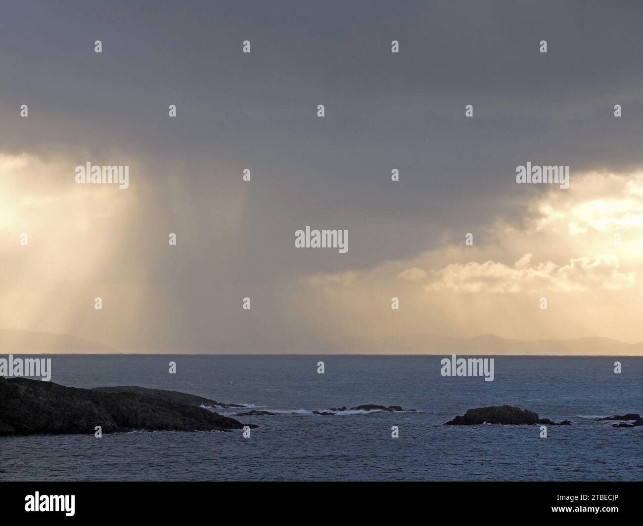 Moody landscape with sunlight highlighting dramatic clouds over golden ...