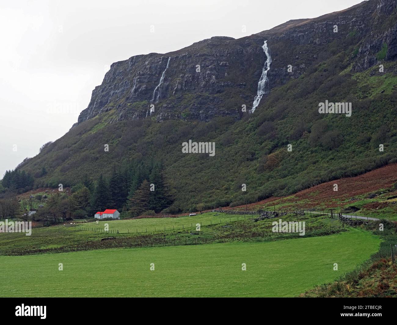 island landscape with high crags and tumbling windblown waterfalls ...