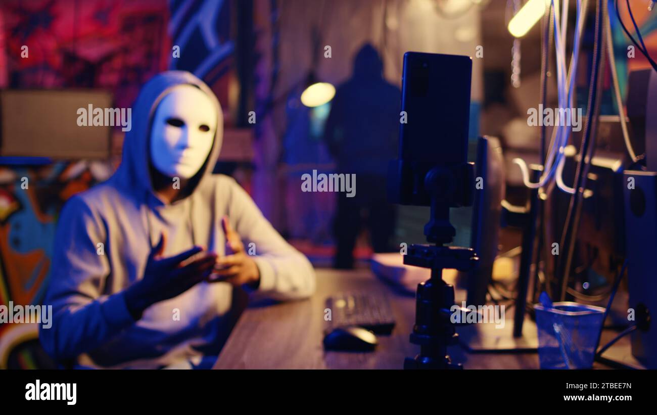 Hacker Wearing Anonymous Mask Threatens Victim With Deploying Malware Designed To Exploit