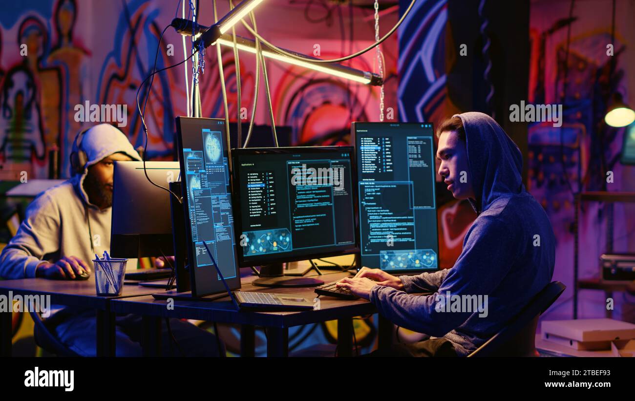 Asian hacker arriving in underground bunker, ready to do data breaches ...