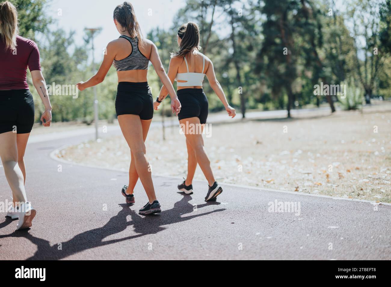 Active and attractive women enjoying outdoor sports, running in a sunny ...