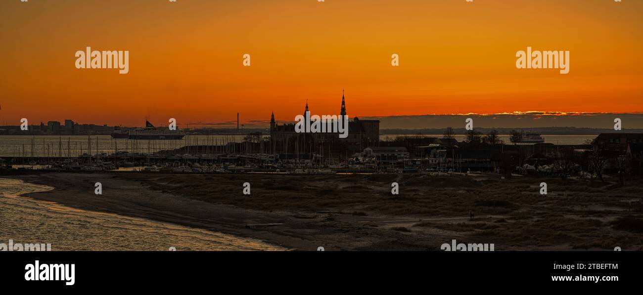 sunrise over Sweden and Kronborg Castle in silhouette and a ferry in ...