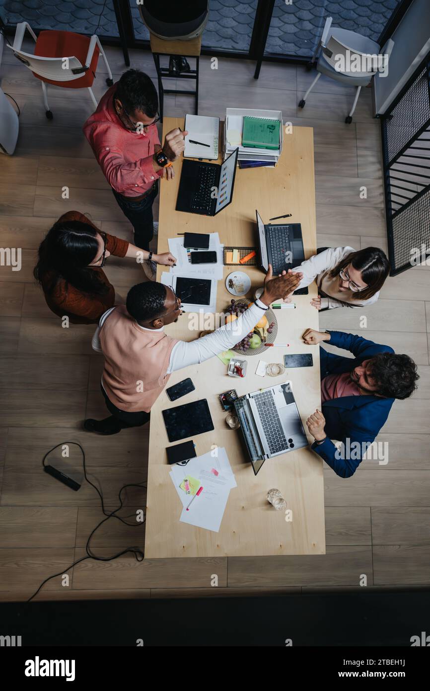 Above view shot of cross-generational team collaborating on business ...