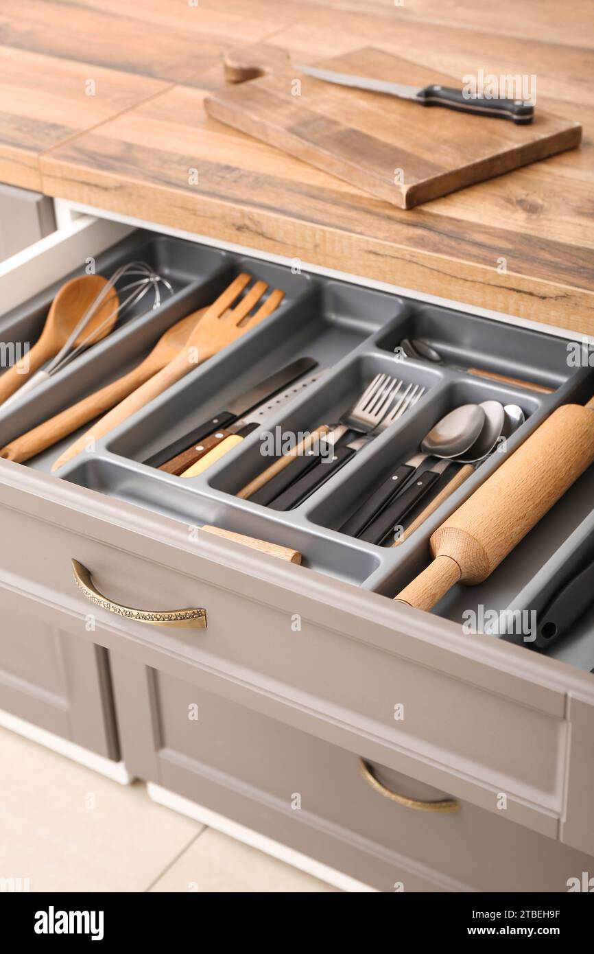 Open kitchen drawer with different silver cutlery Stock Photo - Alamy