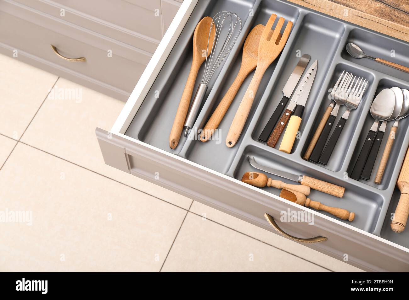 Open kitchen drawer with different silver cutlery Stock Photo - Alamy