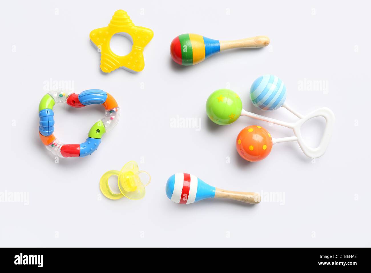 Baby rattles and pacifier on white background Stock Photo - Alamy