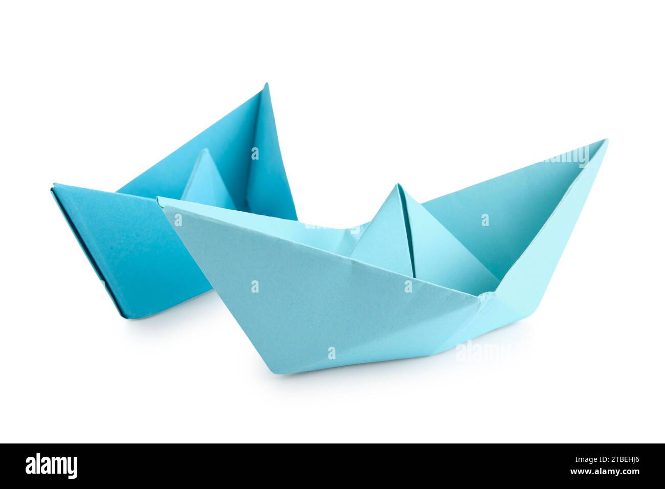 Blue origami boats on white background Stock Photo - Alamy