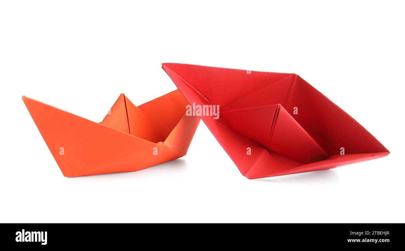 Red origami boats on white background Stock Photo - Alamy