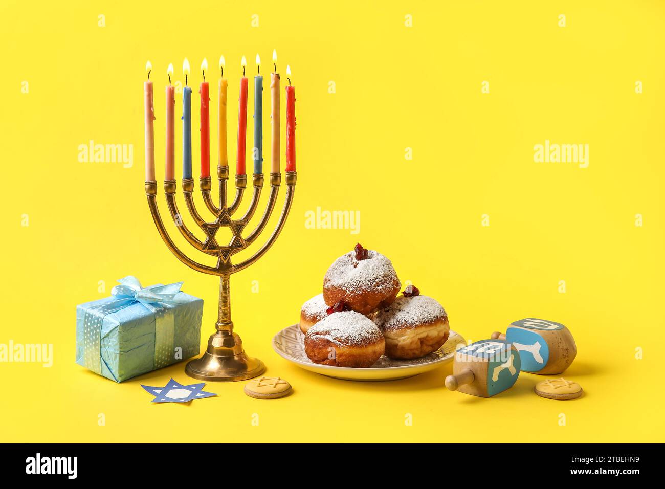 Menorah, dreidels, plate with donuts and gift box for Hanukkah ...