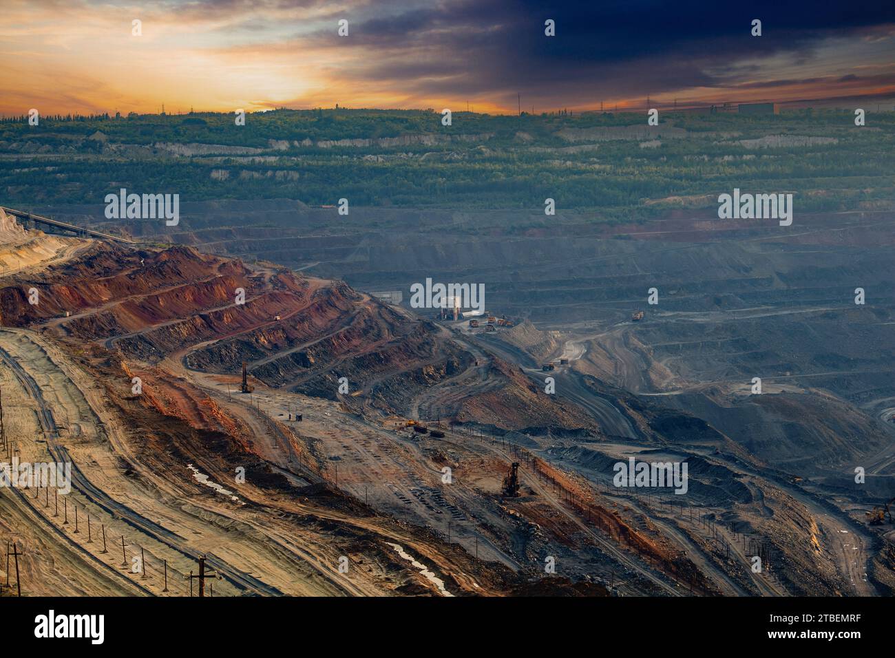 Excavators and dump trucks working on earthmoving at open pit mine in ...