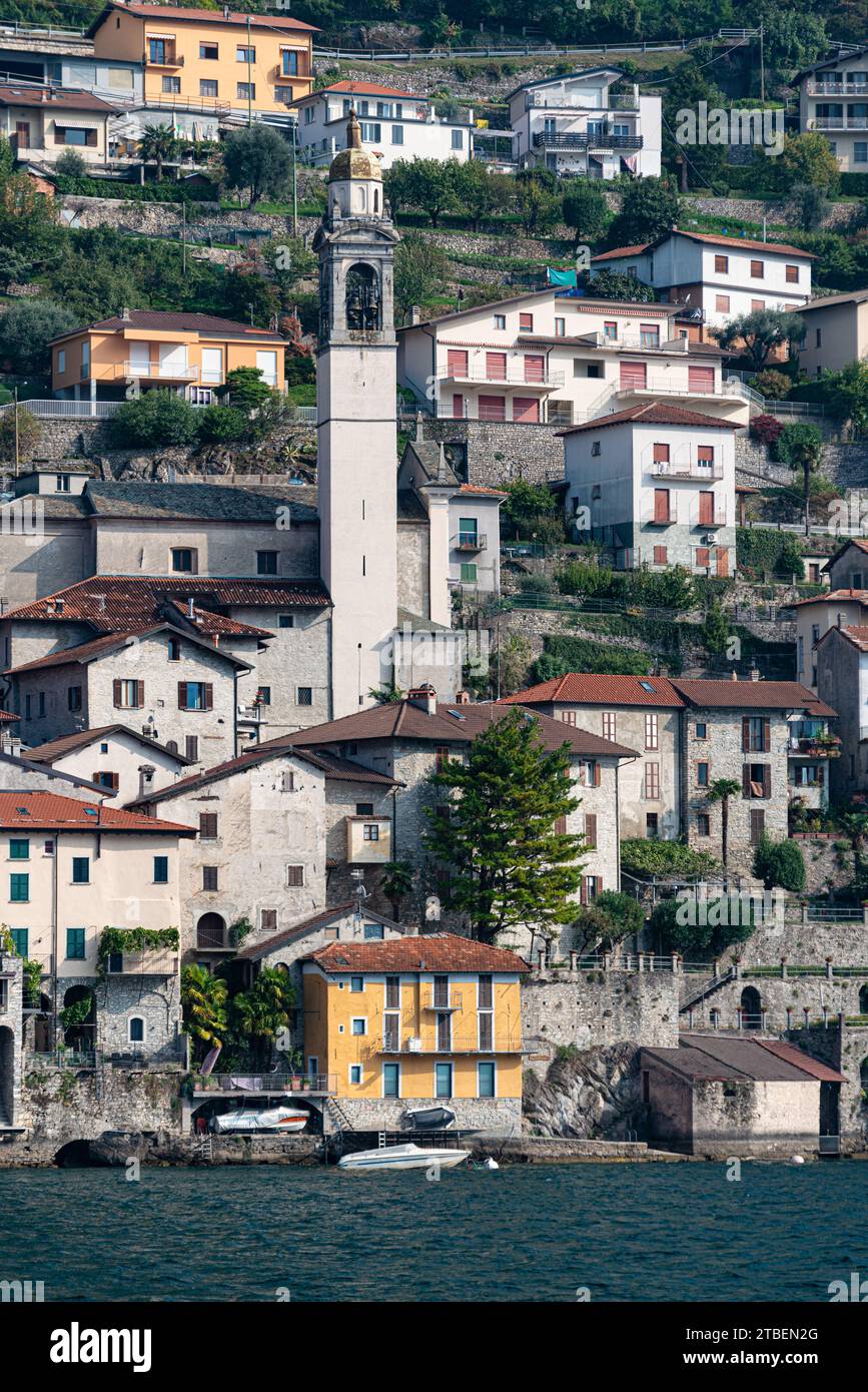 Blevio, Italy photographed from out in Lake Como featuring church tower ...