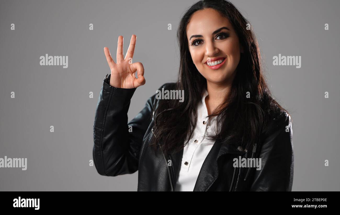 Young woman does an okay pose Stock Photo - Alamy