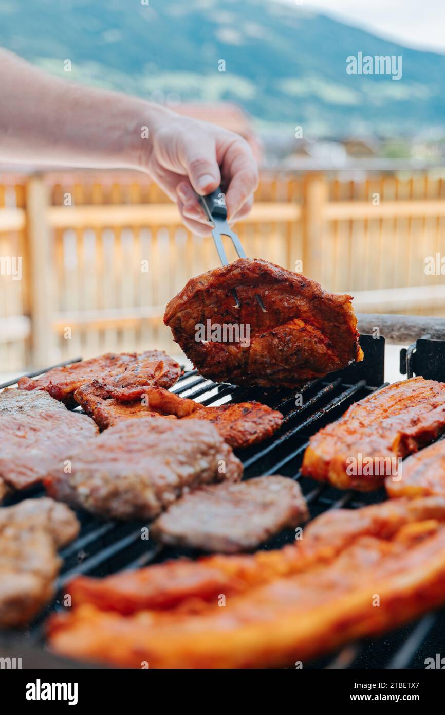 Cook turns meat on grill hi-res stock photography and images - Alamy