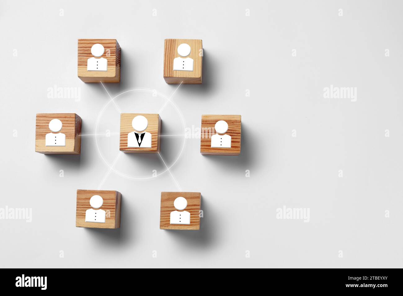 Team management. Wooden cubes with human icons linked together ...