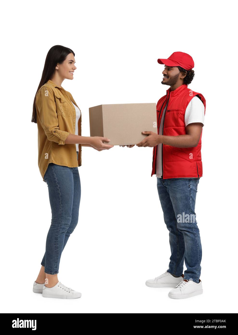 Smiling delivery man giving Cut Out Stock Images & Pictures - Alamy
