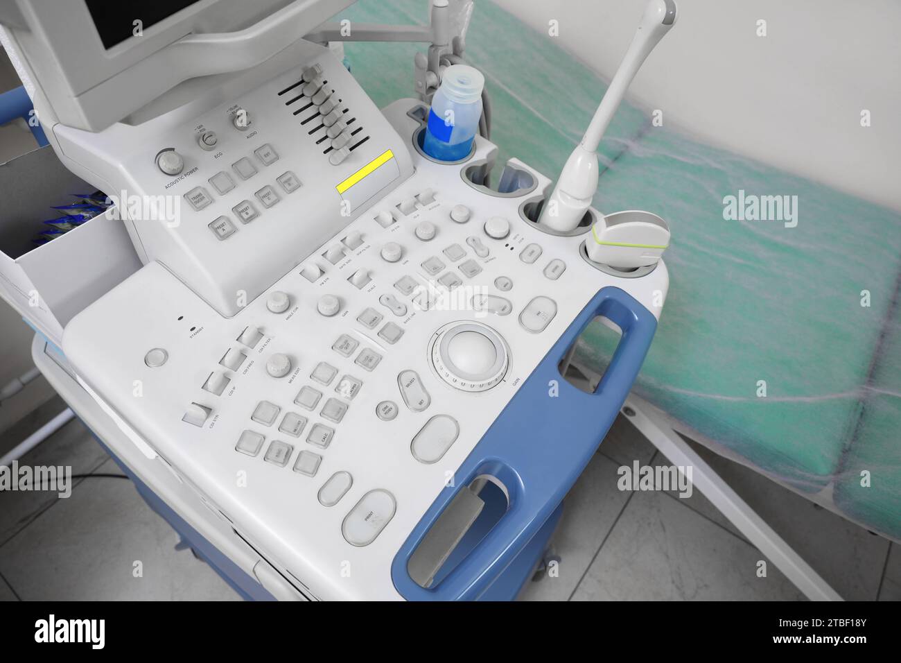 Ultrasound control panel and examination table in hospital, closeup ...