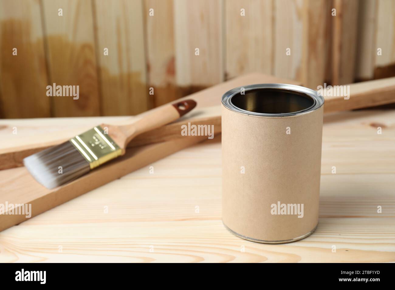 Can with wood stain on wooden surface. Space for text Stock Photo - Alamy