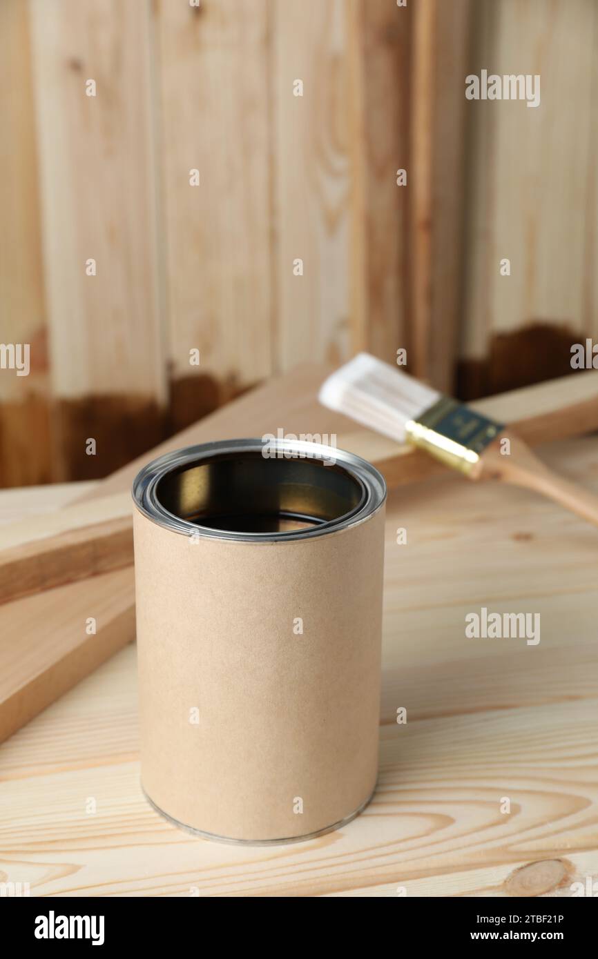 Can with wood stain on wooden surface. Space for text Stock Photo - Alamy