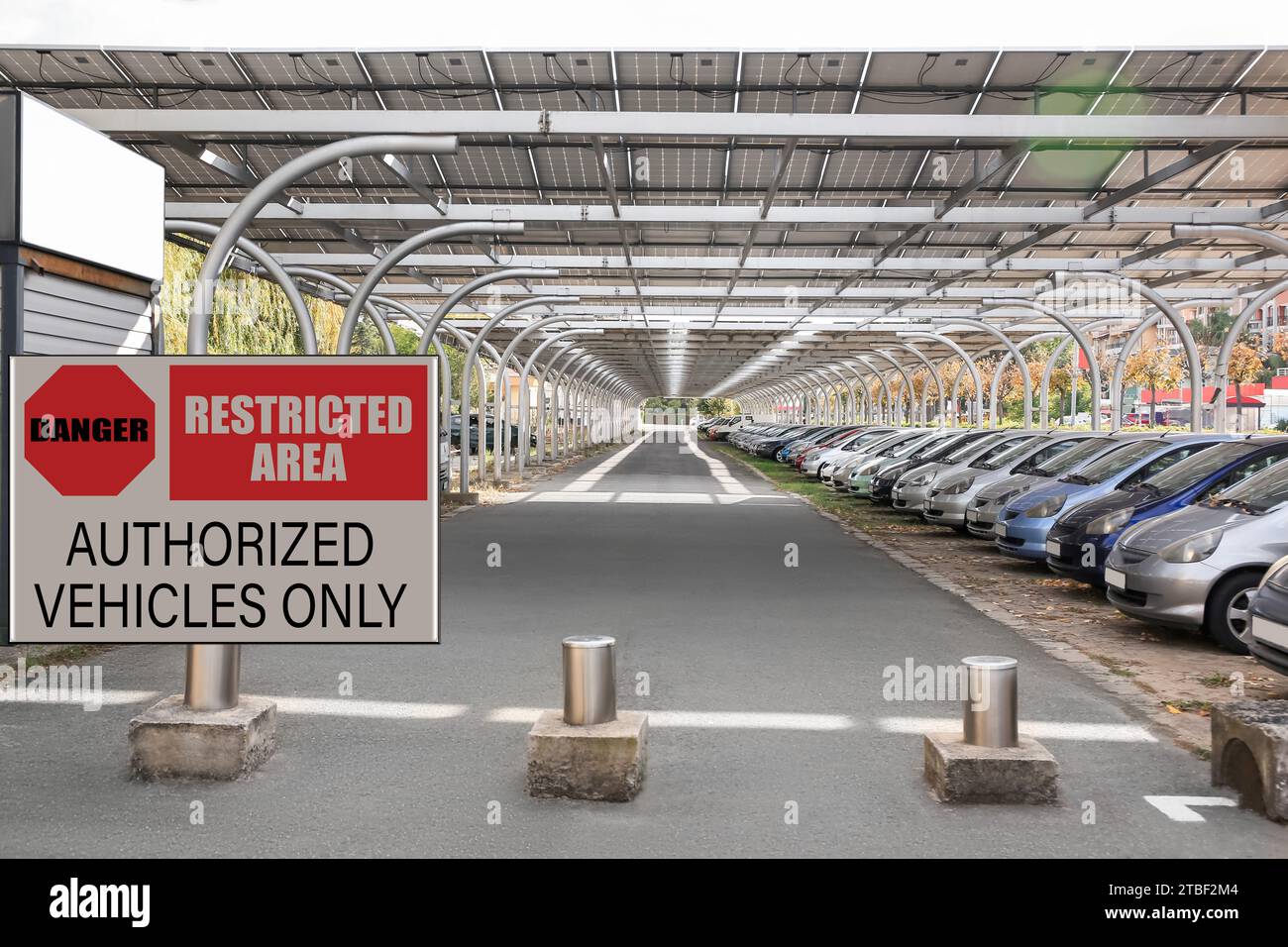 Sign with text Restricted Area Authorized Vehicles Only on bollard near ...