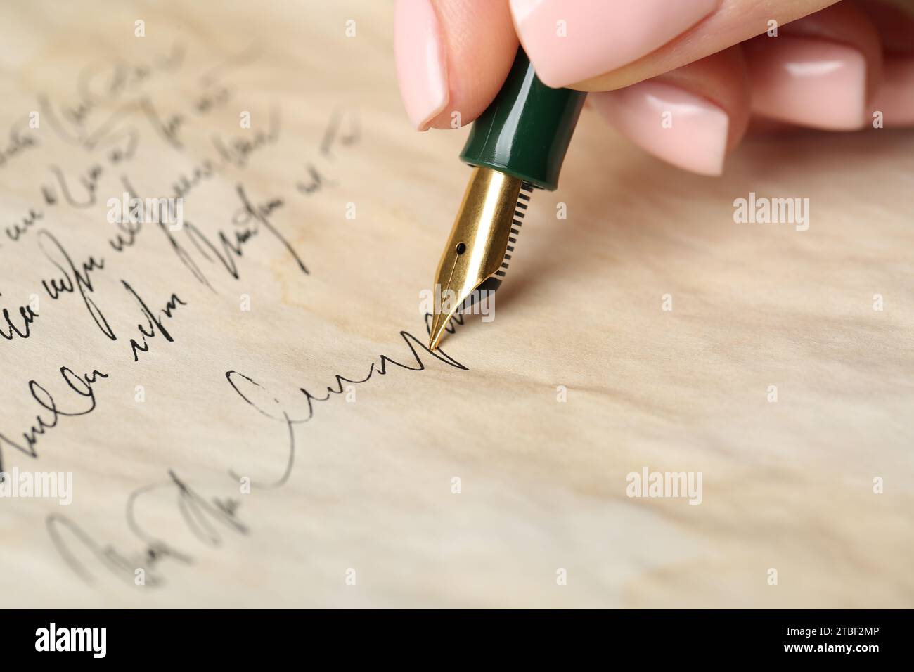 Woman writing letter with fountain pen, closeup Stock Photo - Alamy
