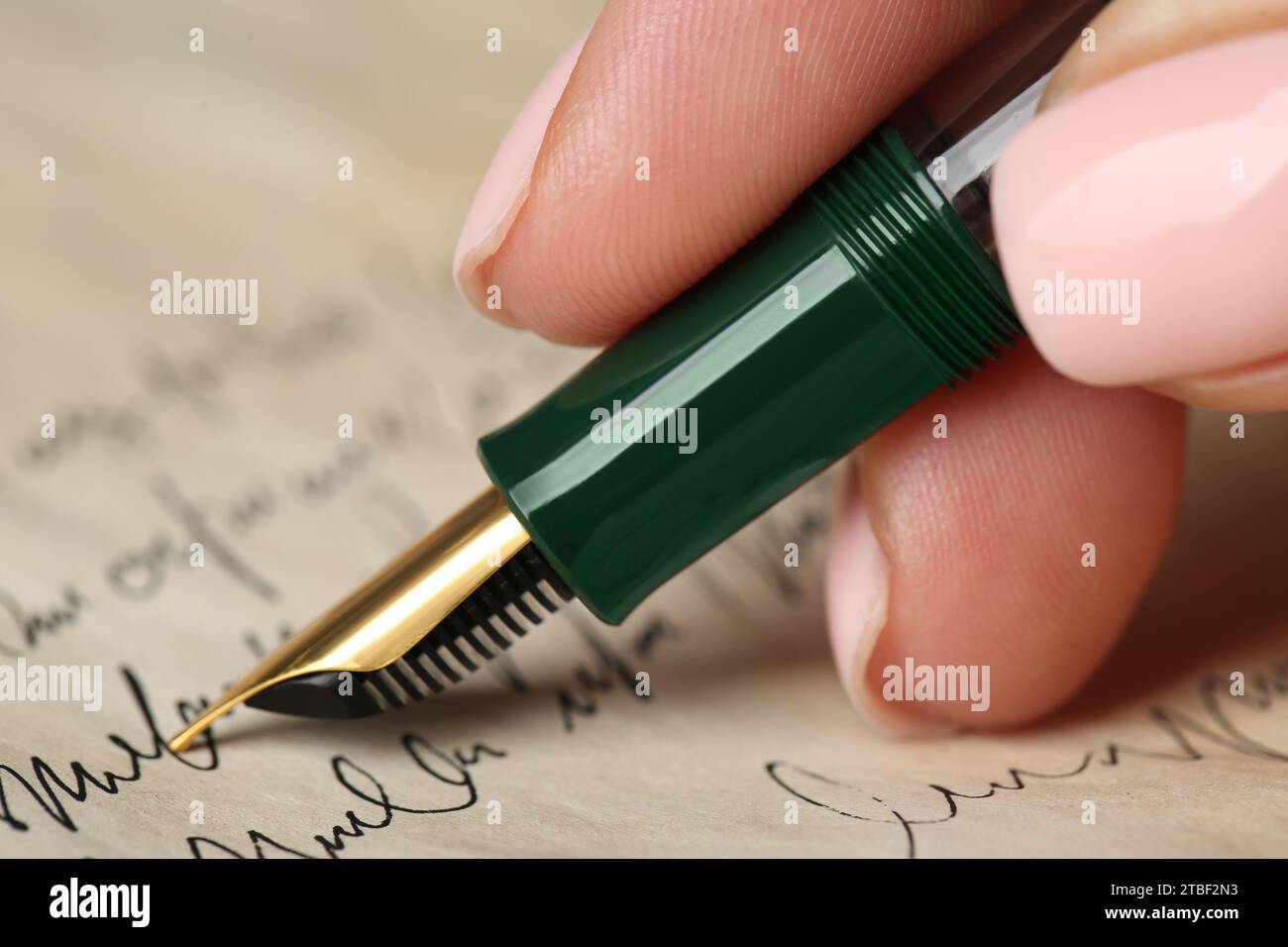 Woman writing letter with fountain pen, closeup Stock Photo - Alamy