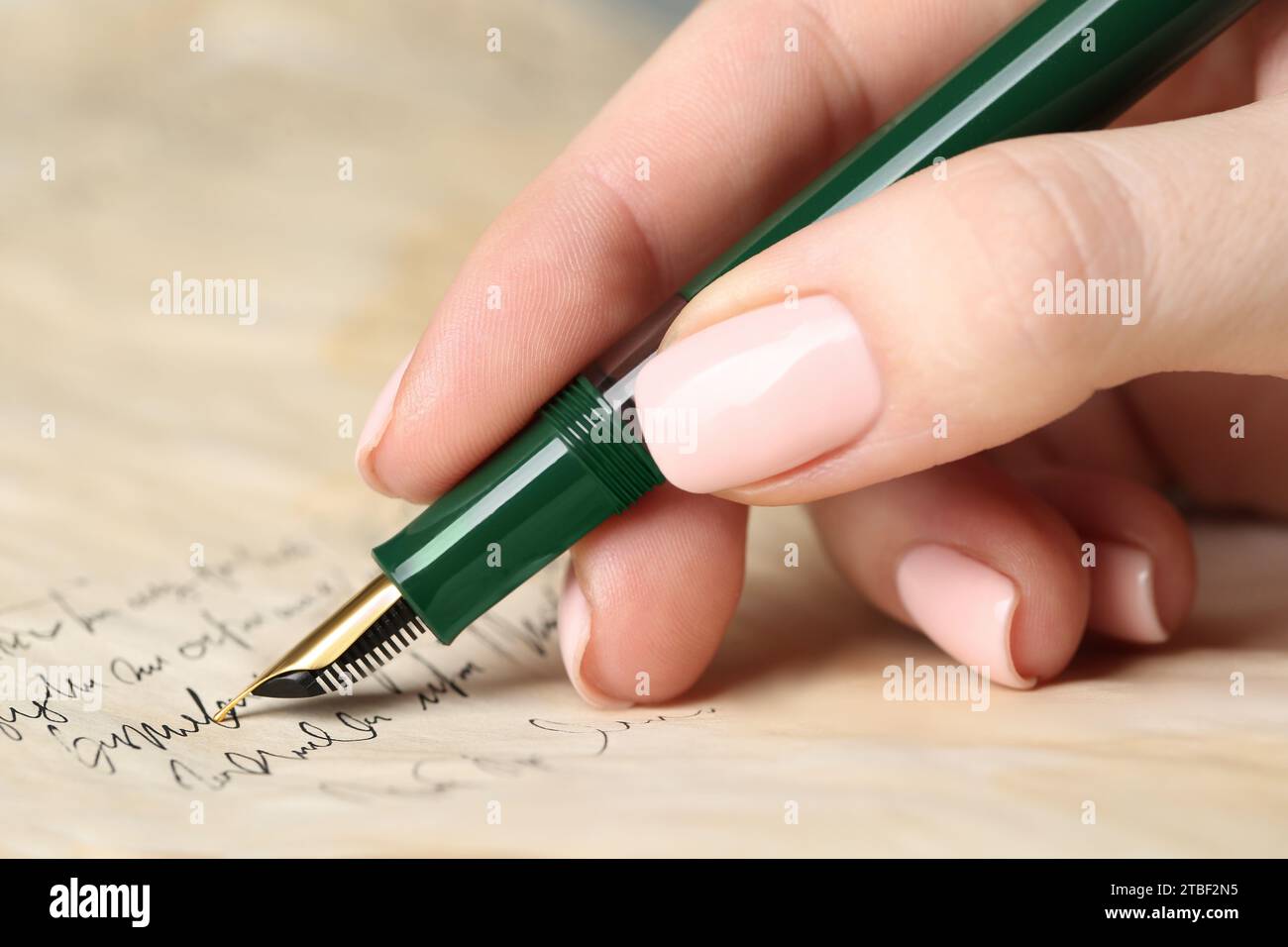 Woman writing letter with fountain pen, closeup Stock Photo - Alamy