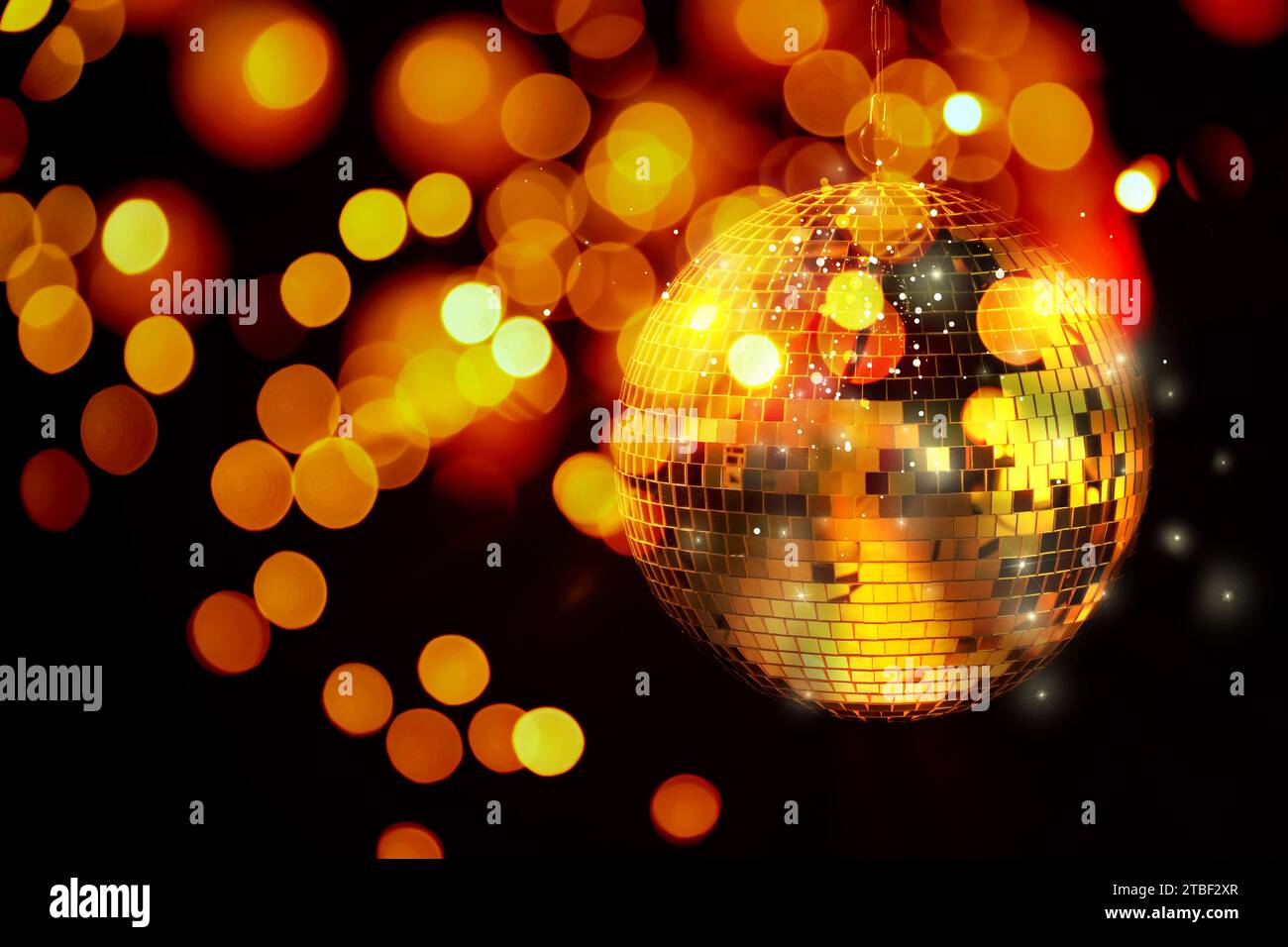 Shiny disco ball on black background with blurred lights, bokeh effect ...
