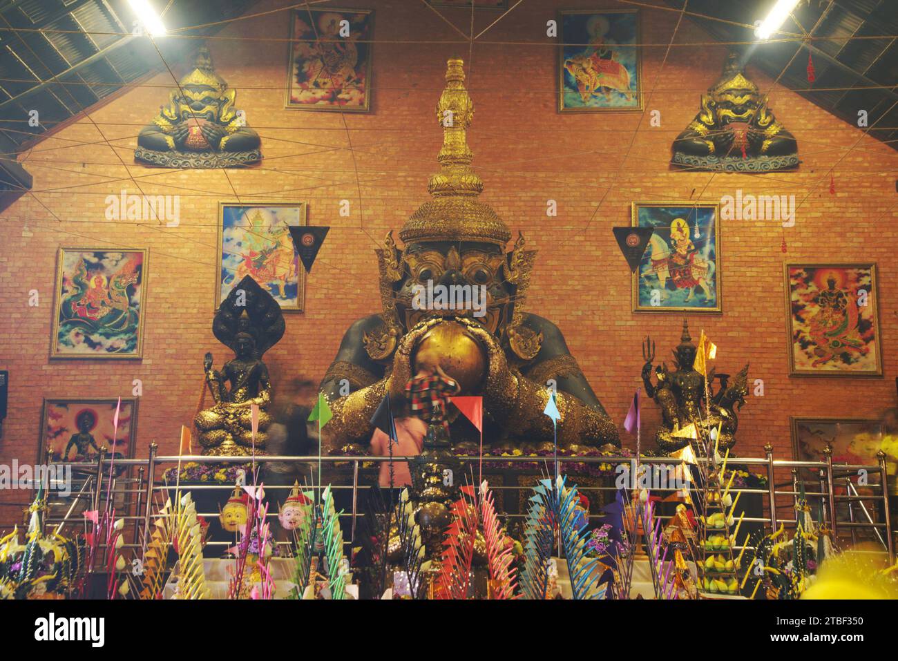 Indoor statue of Phra Rahu suck the moon and many types of offerings at ...