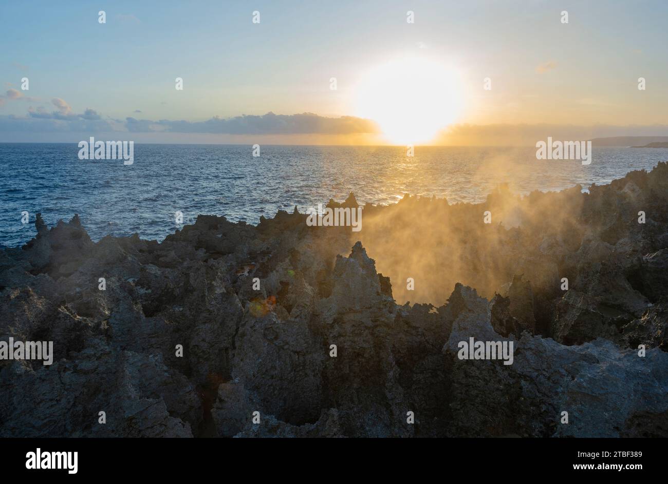 Backlit spray at sunset at the Blowholes, a population tourist ...