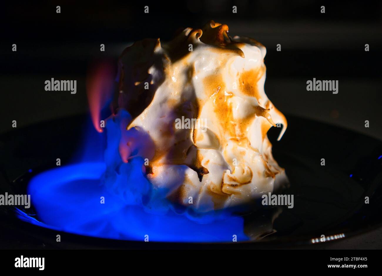 A flaming plate of bombe alaska Stock Photo - Alamy