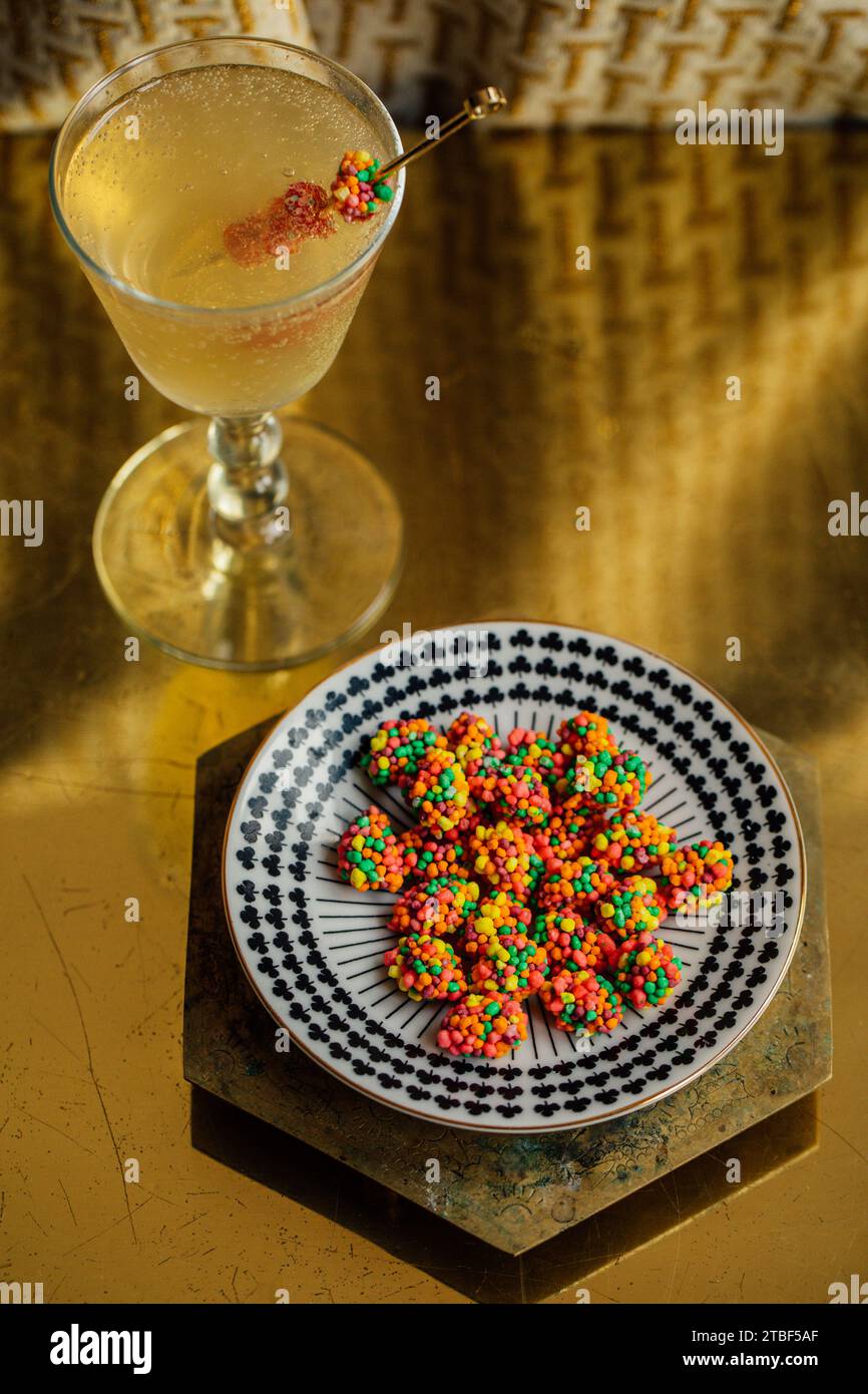 sparkling cocktail drink with candy on cocktail pick and Colorful ...