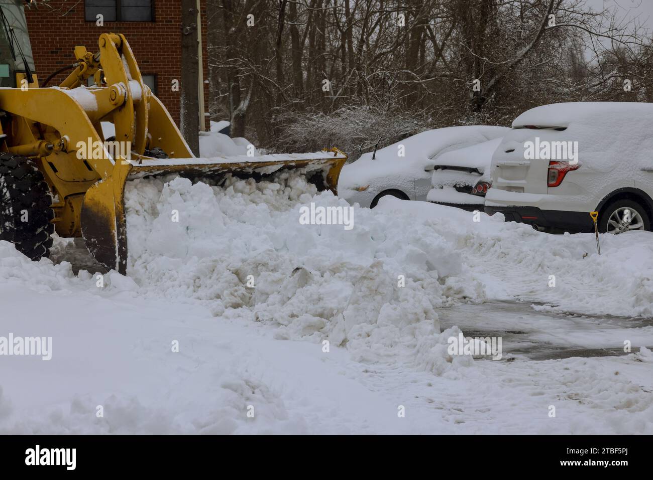 As result of heavy snowfall, snowplows are used to remove snow from ...