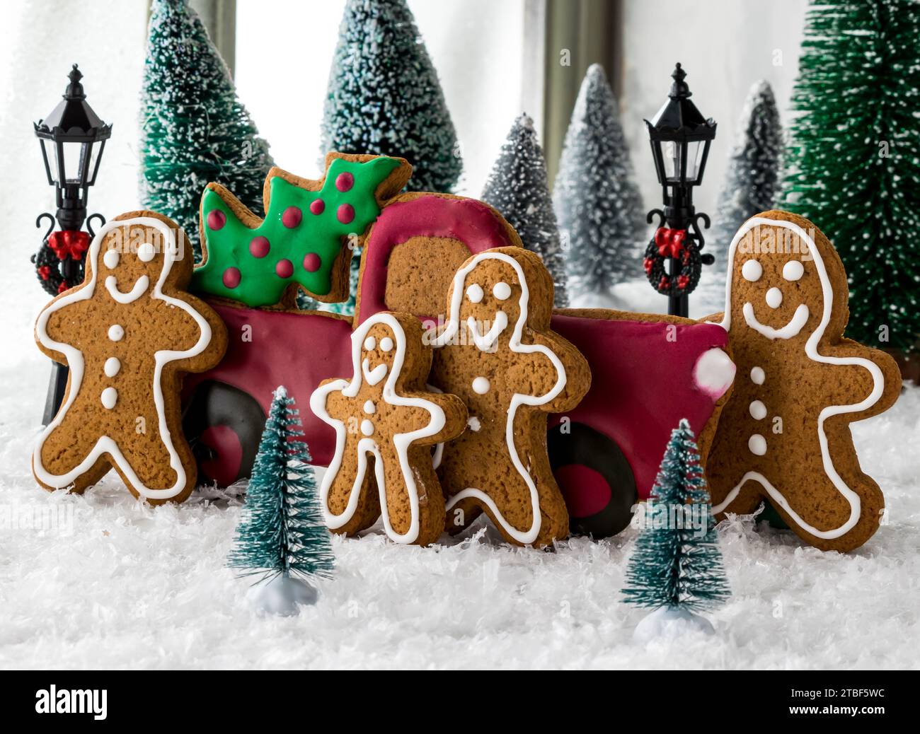 A scene of a gingerbread family in a forest harvesting a tree for the ...