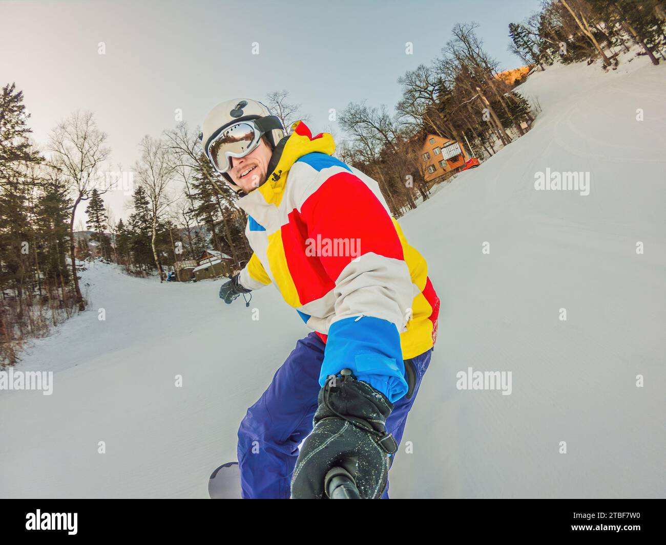 A daring man conquers snowy slopes with style, showcasing skill and ...